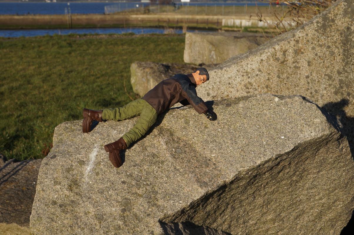 Action Man climbing a rock.